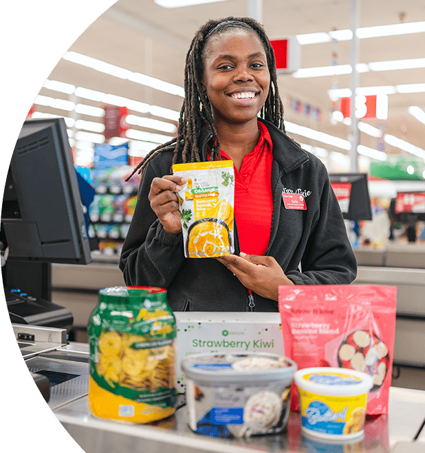 Smiling female Winn-Dixie cashier at check out with award-winning Own ...